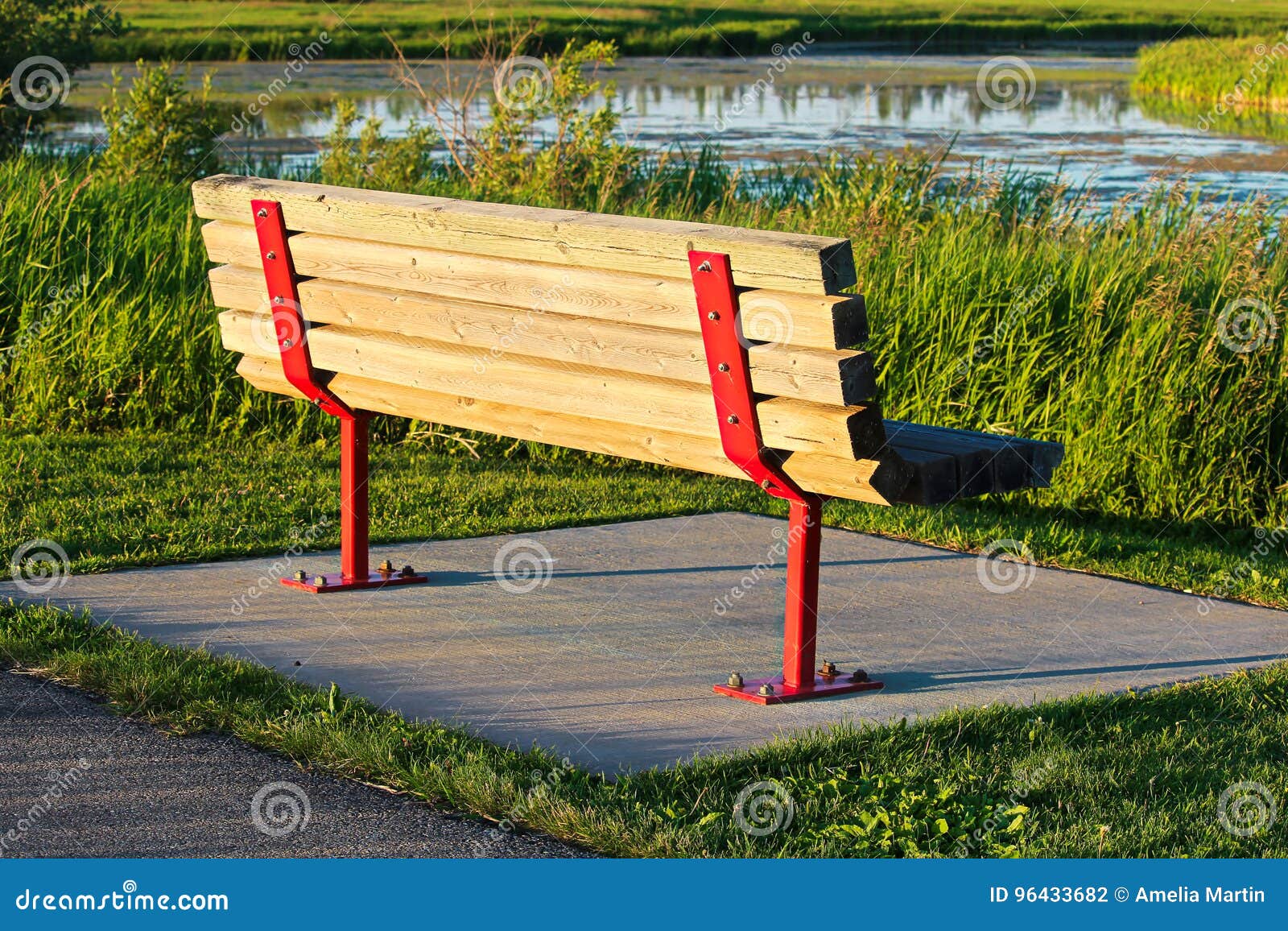 A Park Bench on a Concrete Base Overlooking a Scenic Marsh Stock Photo ...