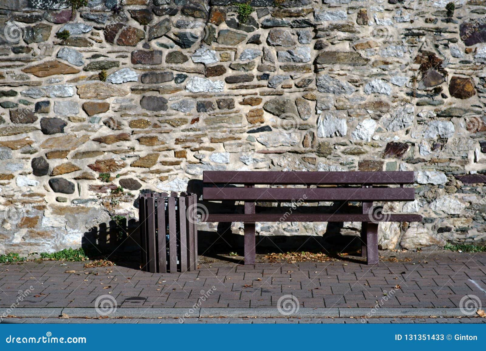 Park Bench in Front of Field Stone Wall Stock Image - Image of bench ...