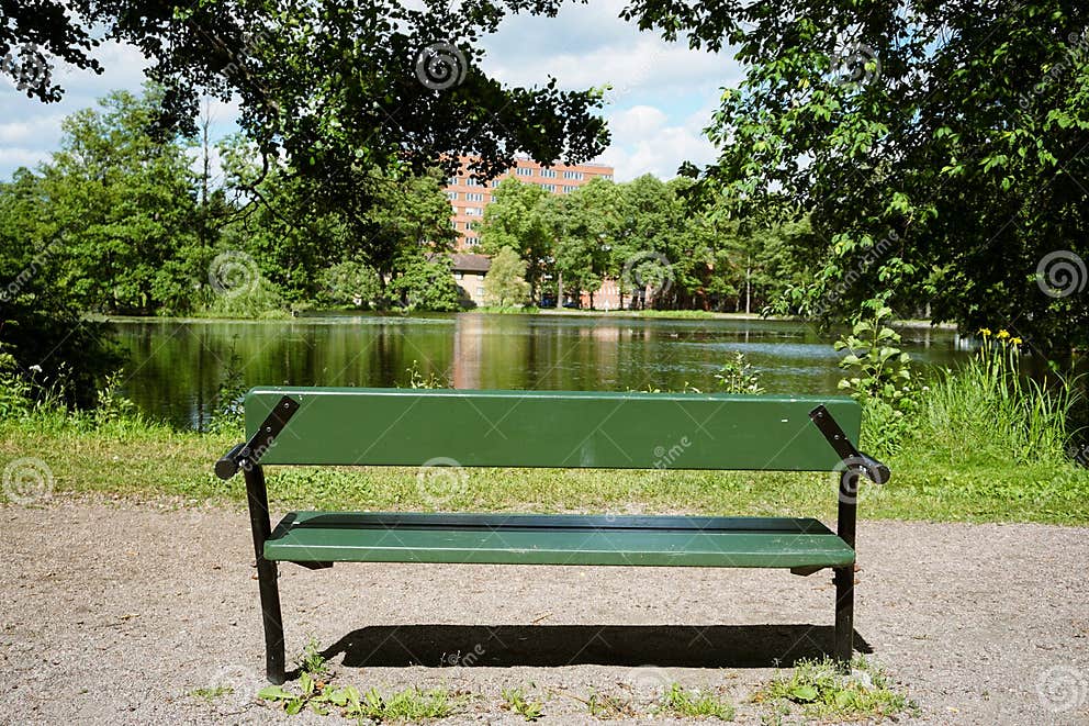 A Park Bench in Front of a Lake Stock Image - Image of pond, furniture ...