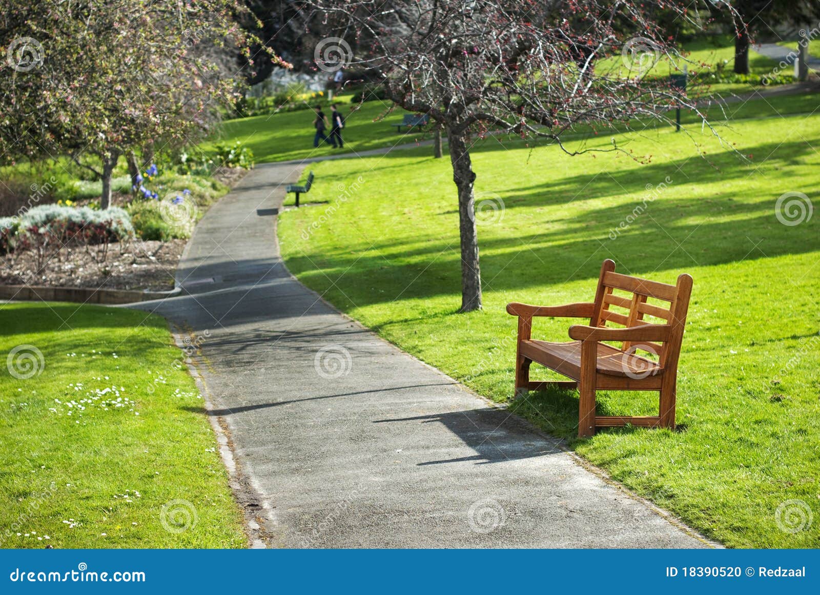Park Bench and Path Leading To Out of Focus Figure Stock Photo - Image ...