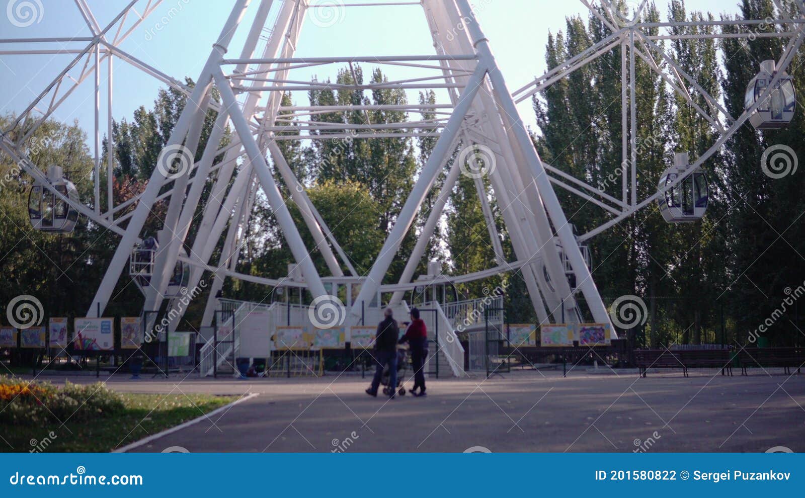 In the Park, a Large Ferris Wheel is Spinning Slowly. High-altitude ...
