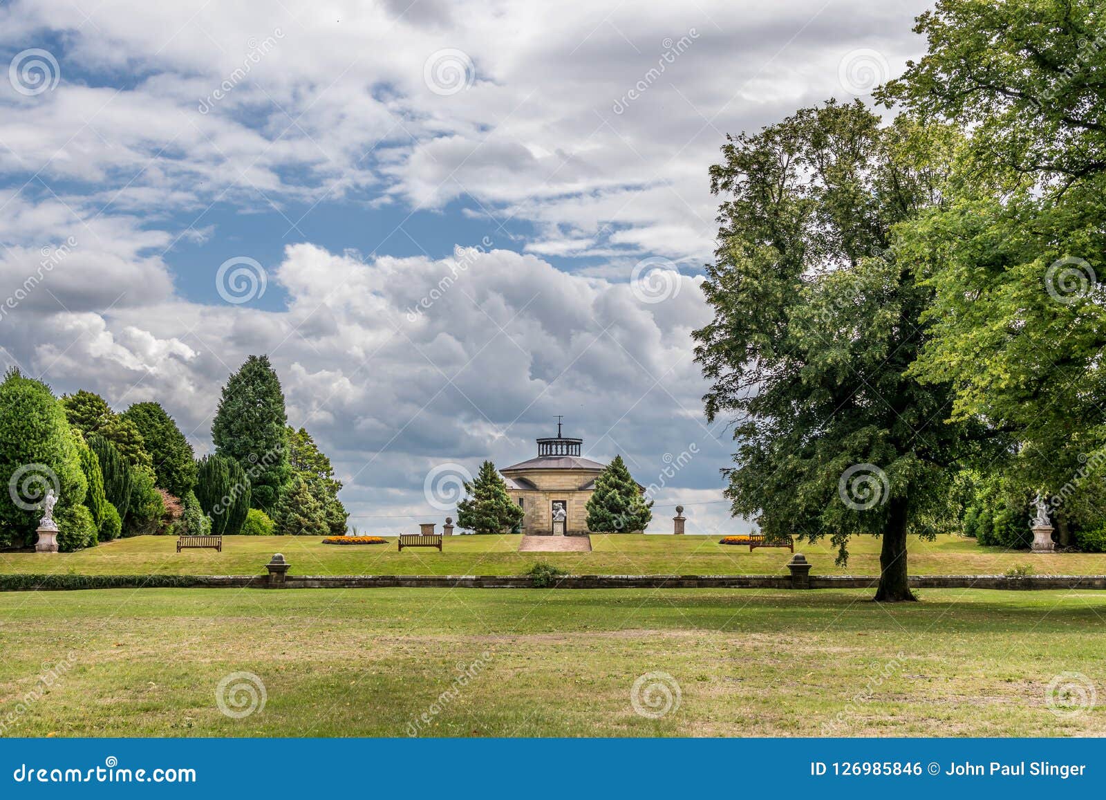 A Park with Statues and a Small Building. Stock Photo - Image of ...