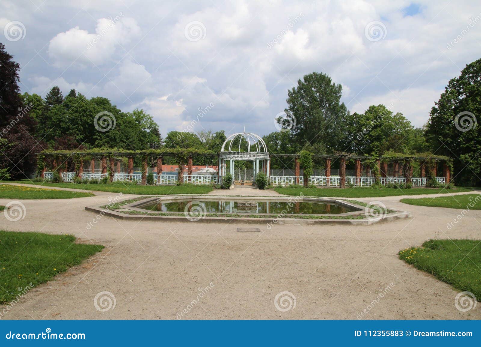 Paths and Fountain in a Park with Symmetrical Architecture on a Cloudy ...
