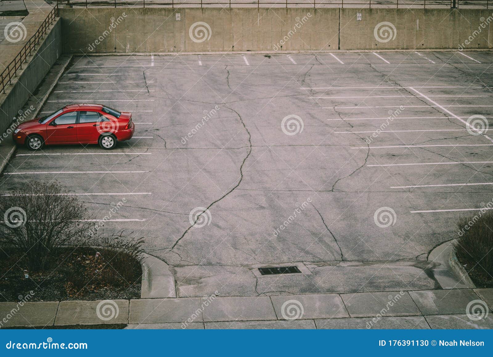 Parking Lot with One Red Car Editorial Image - Image of sidewalk, small ...
