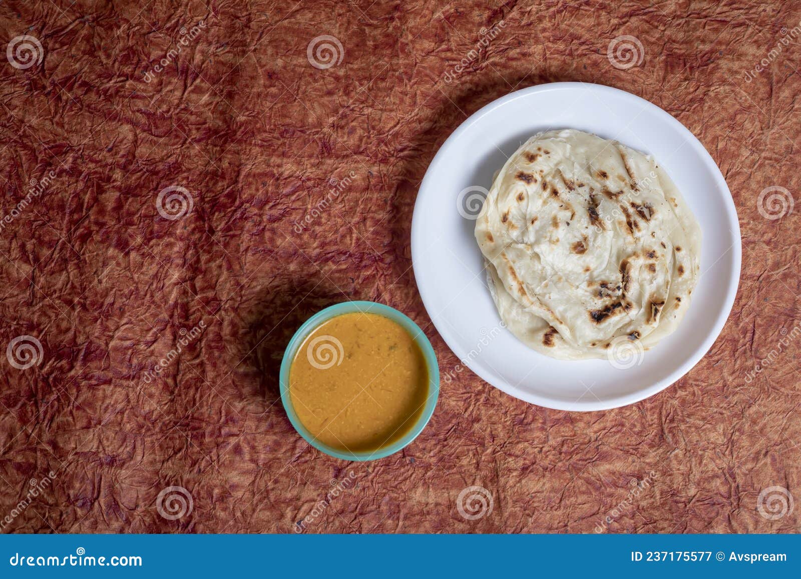 Parotta with Chicken Curry on a White Plate. is a Delicacy from the ...