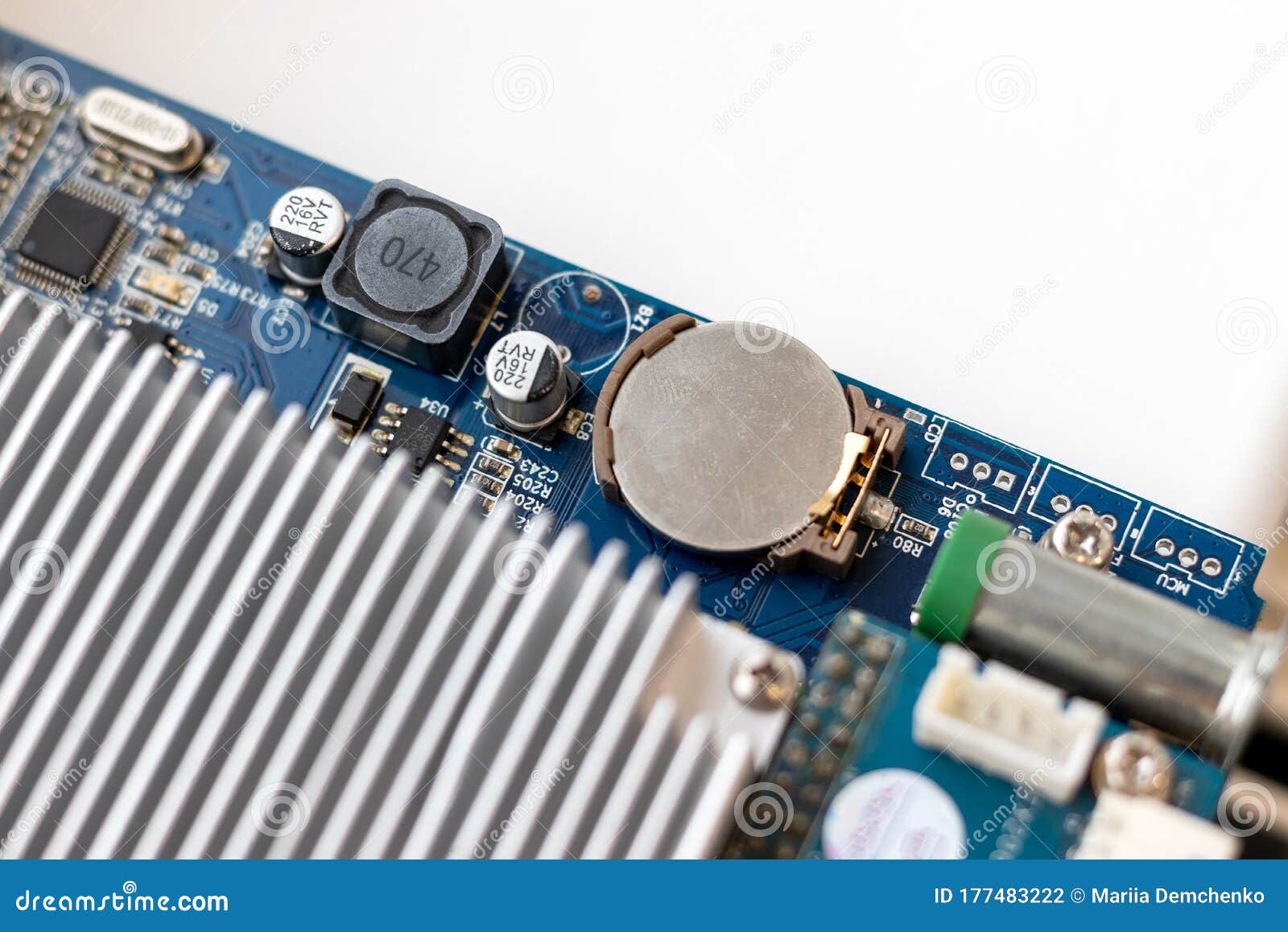 Part of a Computer Motherboard with Capacitors, a Battery and a Cooling ...