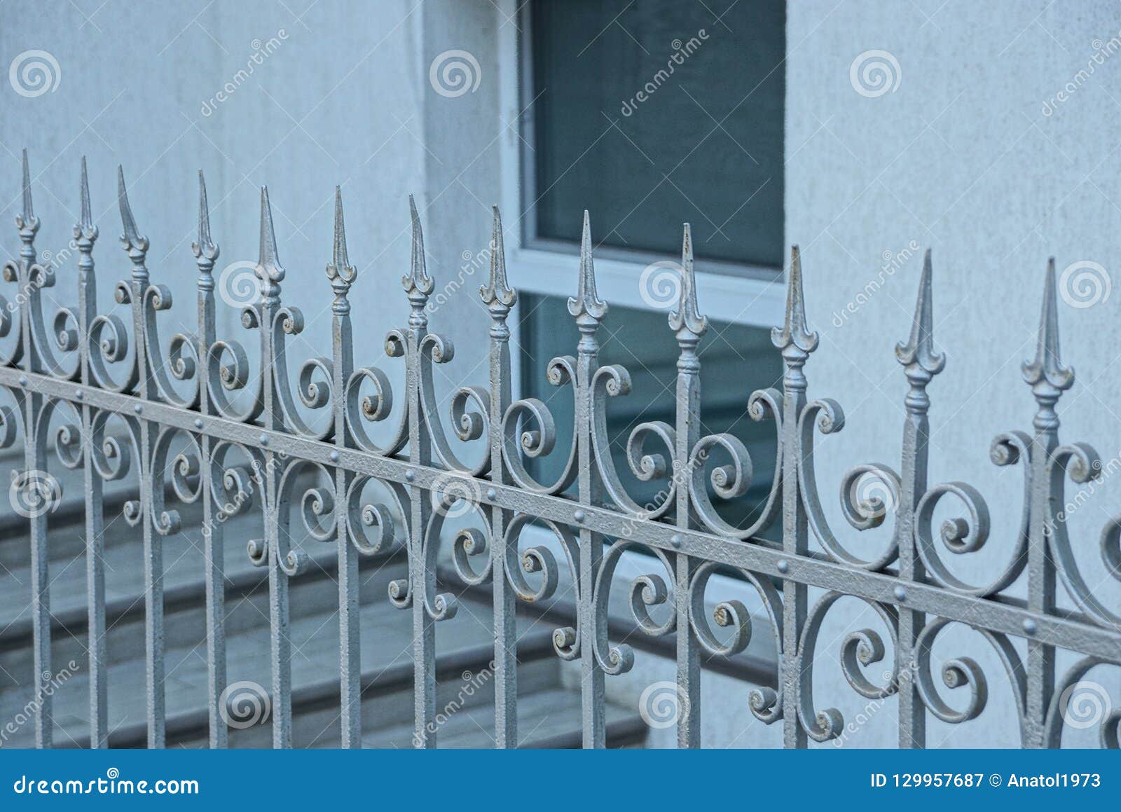 Part of the Fence of Sharp Steel Rods Against the Wall of the House ...