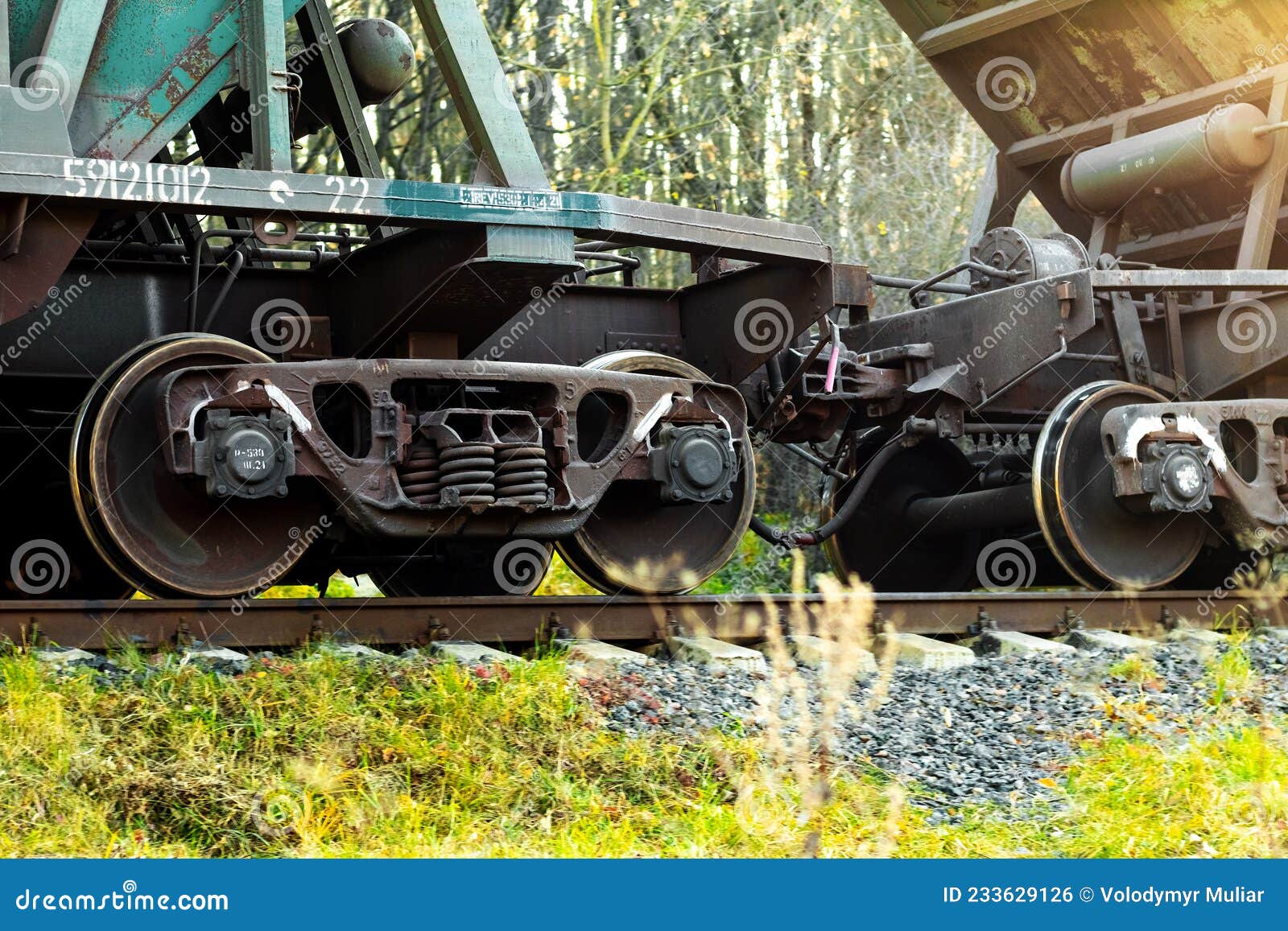 Part of a Freight Car with Massive Wheels during the Movement of the ...