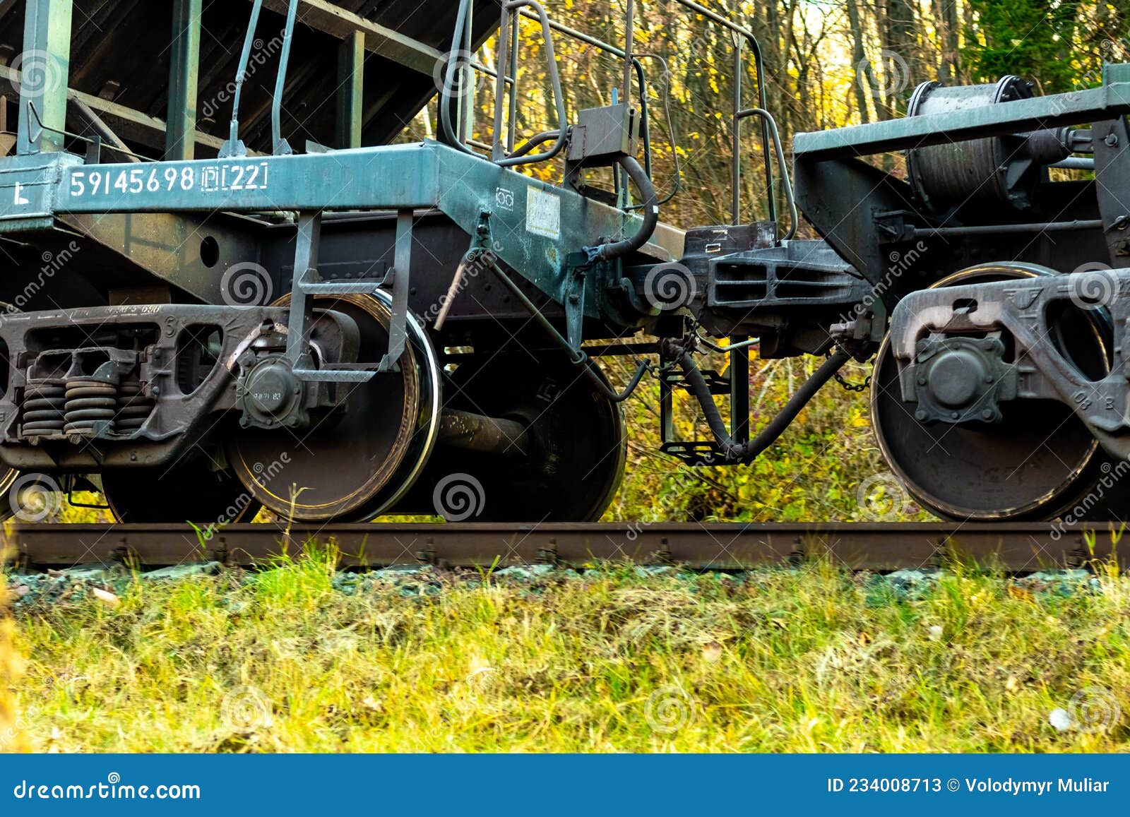 Part of a Freight Car with Massive Wheels during the Movement of the ...