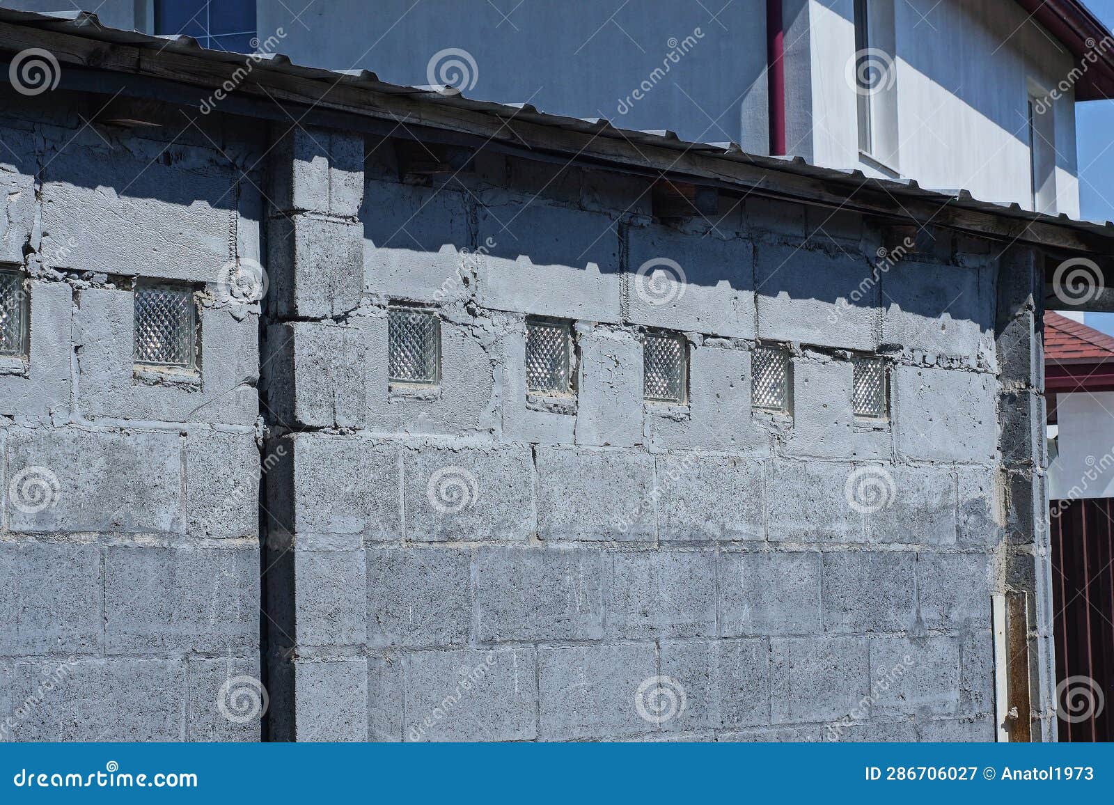 Part of the Gray Brick Attic of the Building with a Row of Small Square ...
