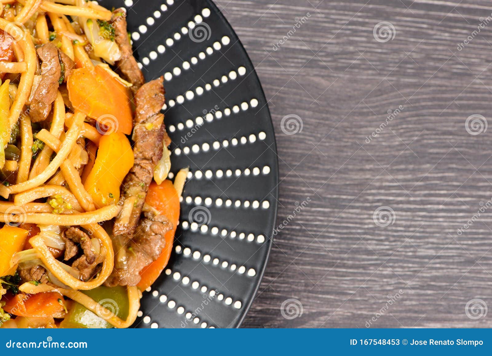 Part of a Plate of Yakisoba on a Dark Wood Table with Space for Writing ...