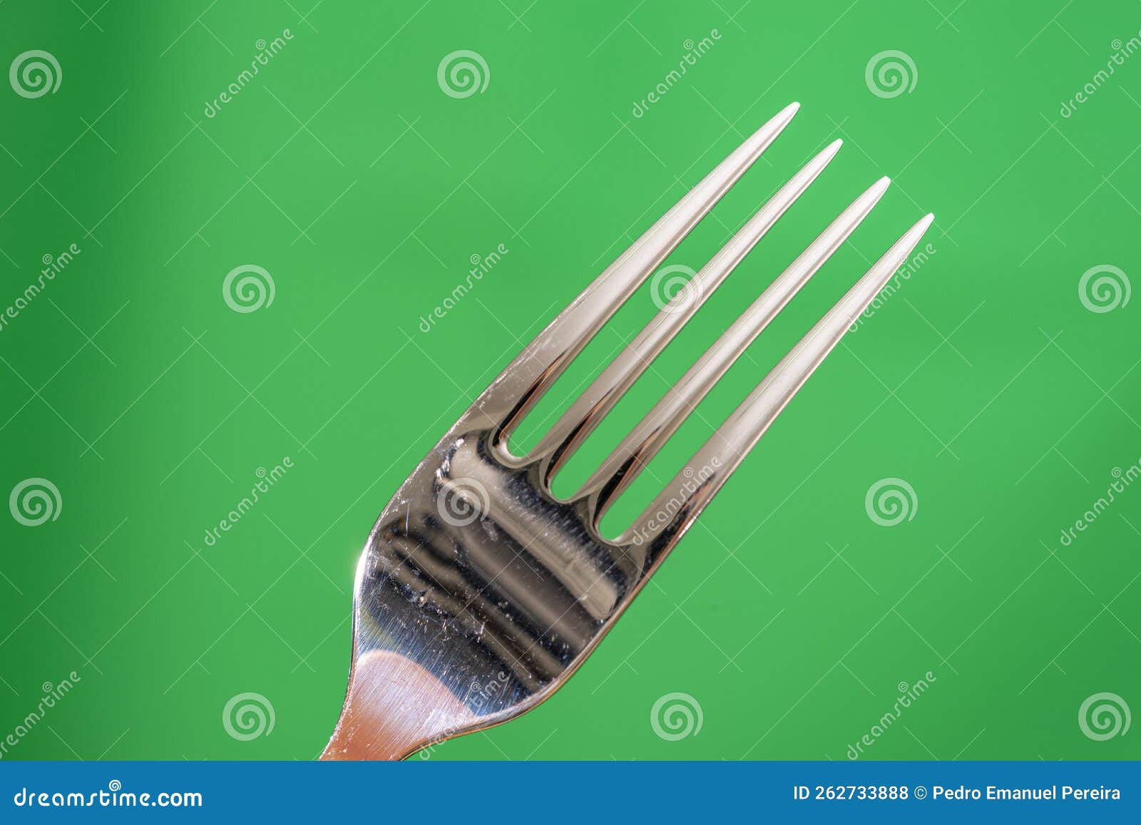 Part of Stainless Steel Fork with 4 Teeth Under Green Background Stock ...