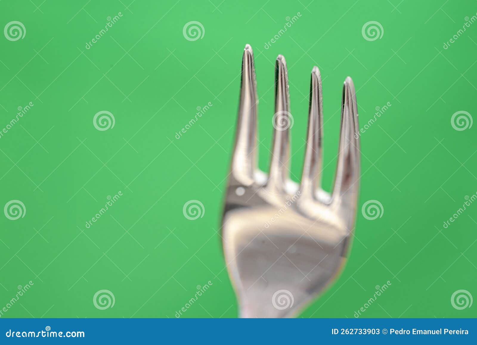 Part of Stainless Steel Fork with 4 Teeth Under Green Background Stock ...