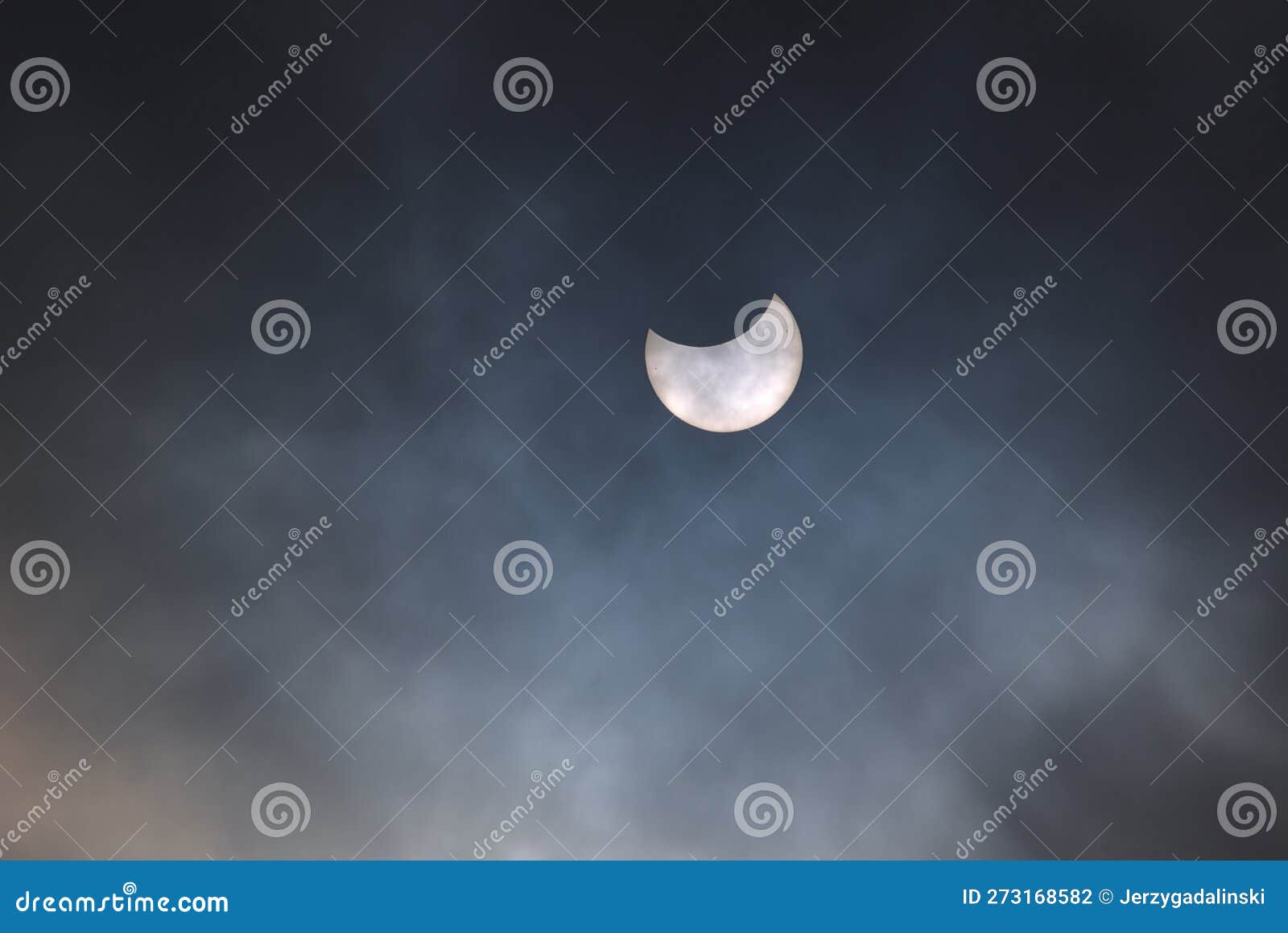 Partial Eclipse of the Sun on a Cloudy Sky Stock Photo - Image of ...