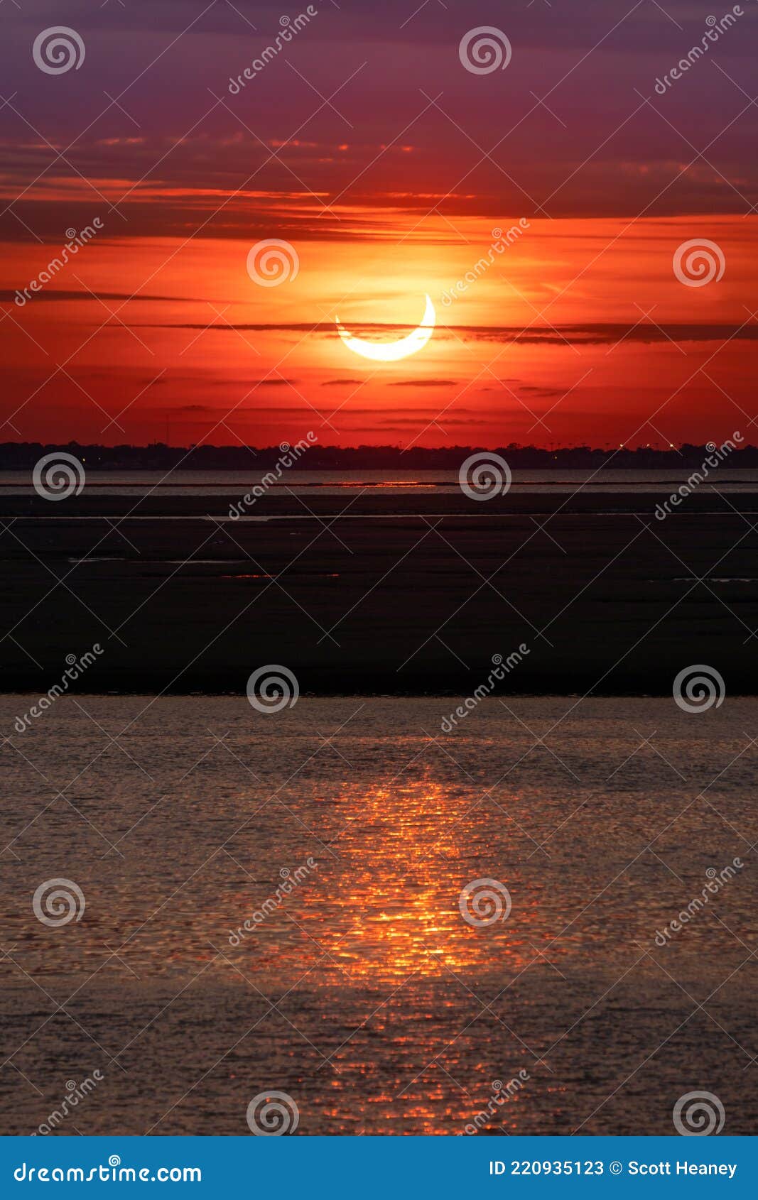 Partial Solar Eclipse with a Reflection in Water. Stock Image - Image ...