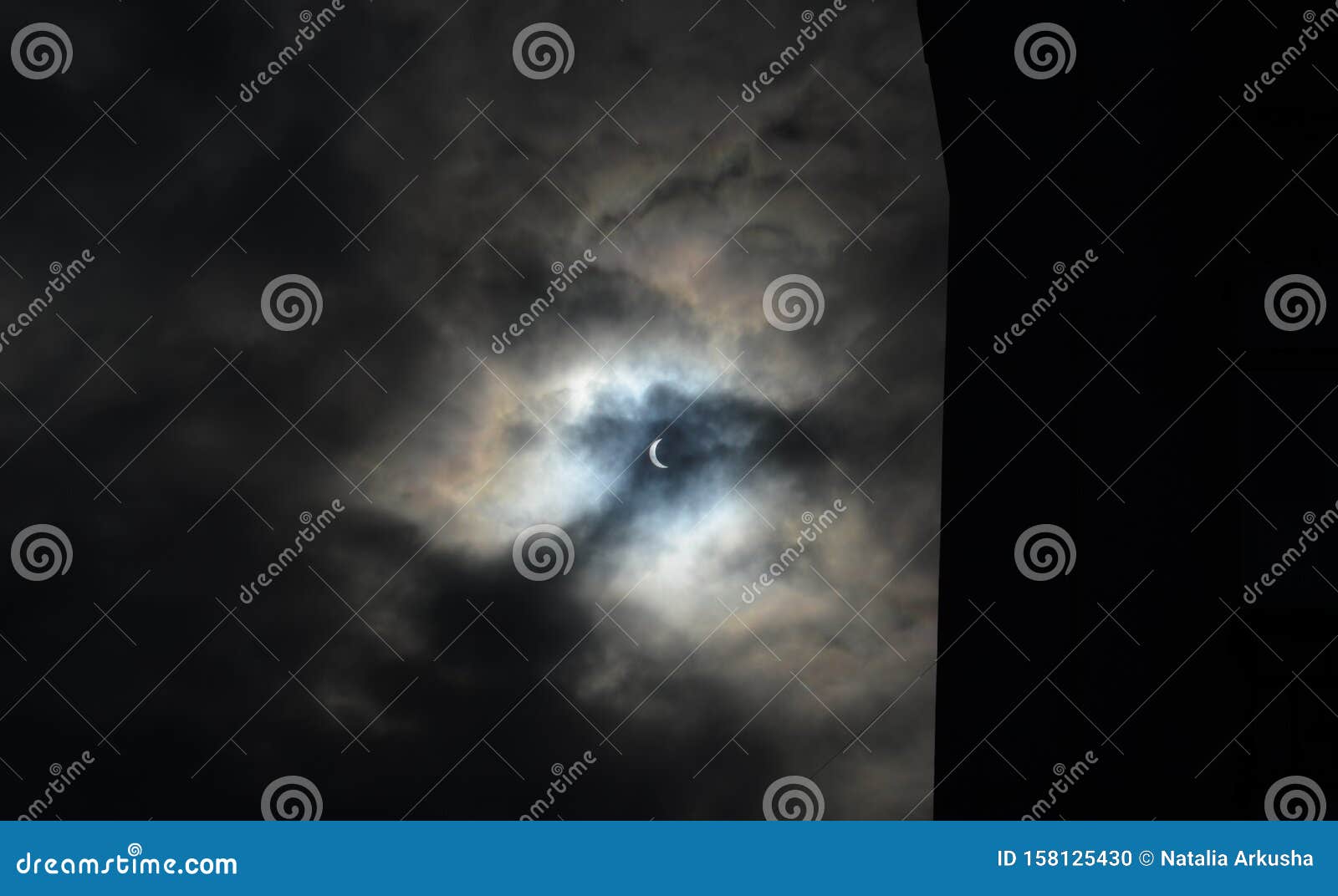 Partial Solar Eclipse Viewed Under Cloudy Skies Stock Photo - Image of ...