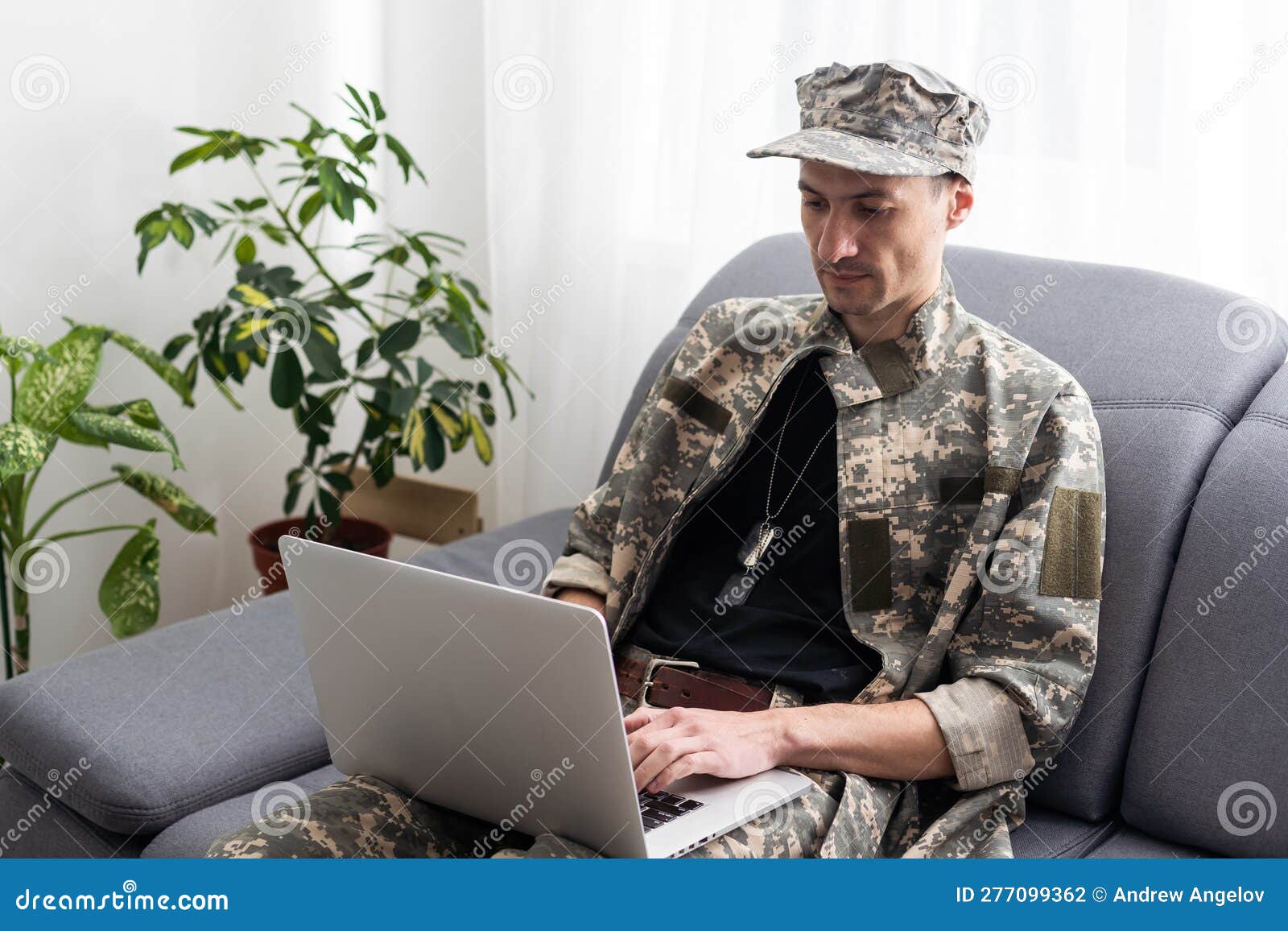 Partial View of Army Soldier Using Laptop on Couch Stock Photo - Image ...