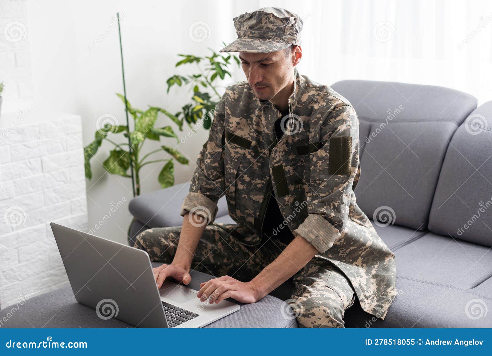 Partial View of Army Soldier Using Laptop on Couch Stock Image - Image ...