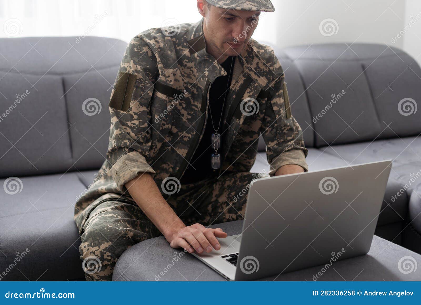 Partial View of Army Soldier Using Laptop on Couch Stock Photo - Image ...