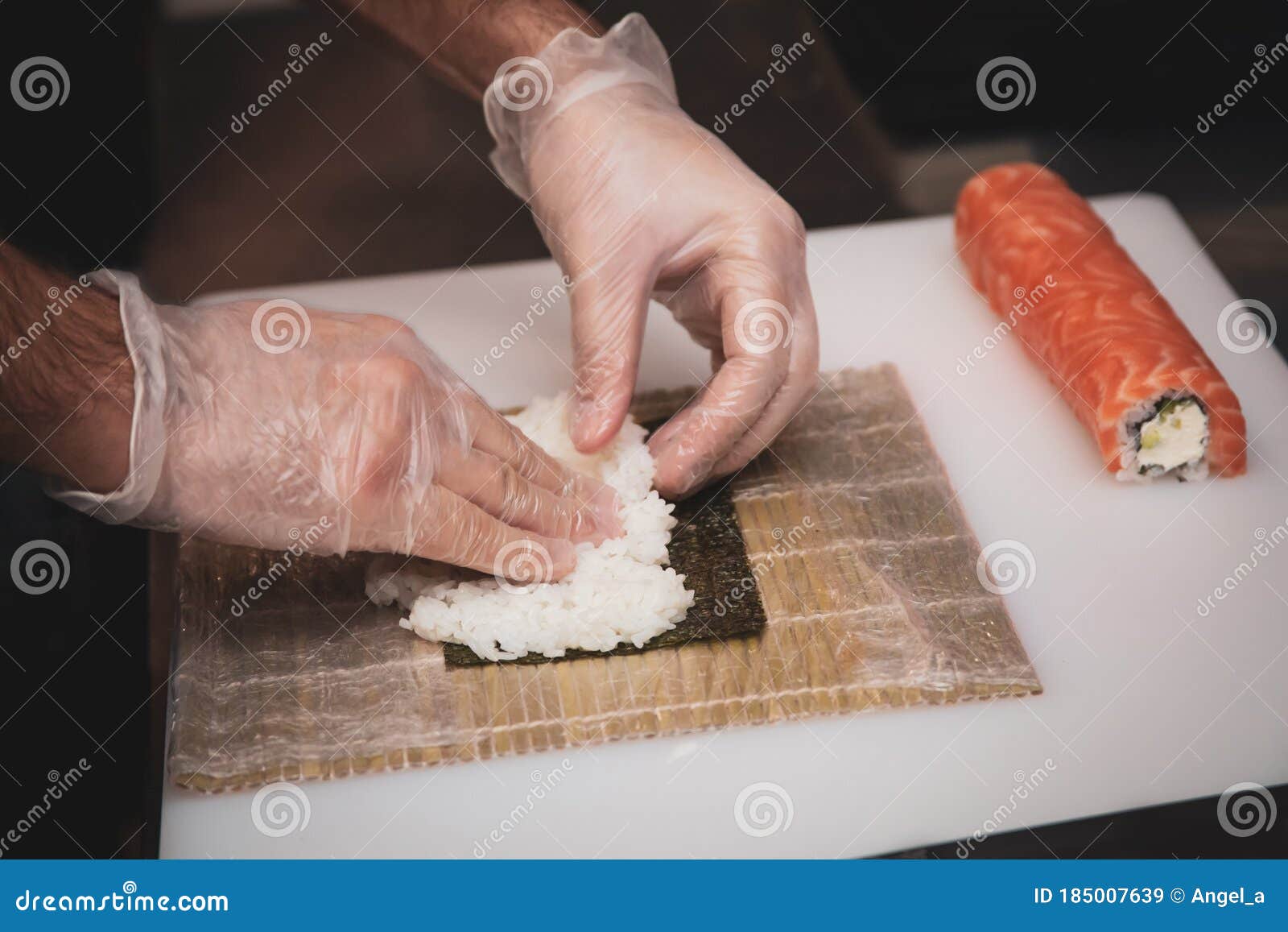 Partial View of Chef Hand Arranging Rice for Sushi Roll on Table on ...