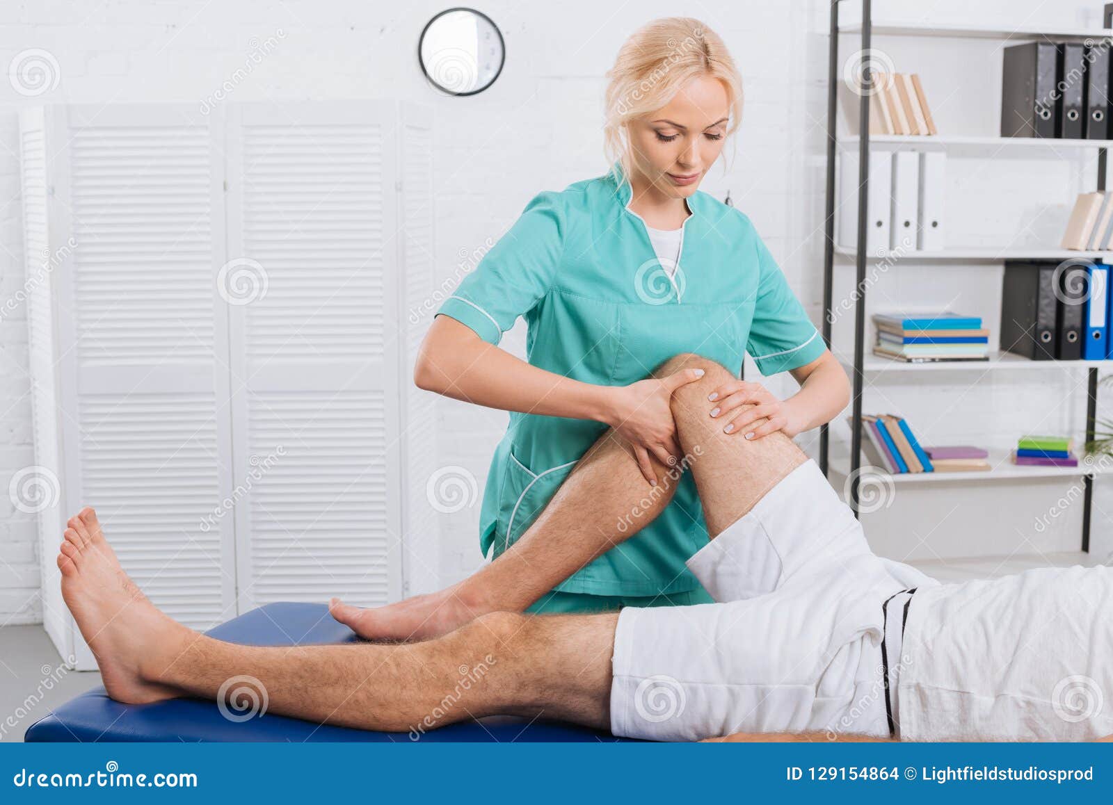 Partial View of Chiropractor Massaging Patients Leg during Appointment ...