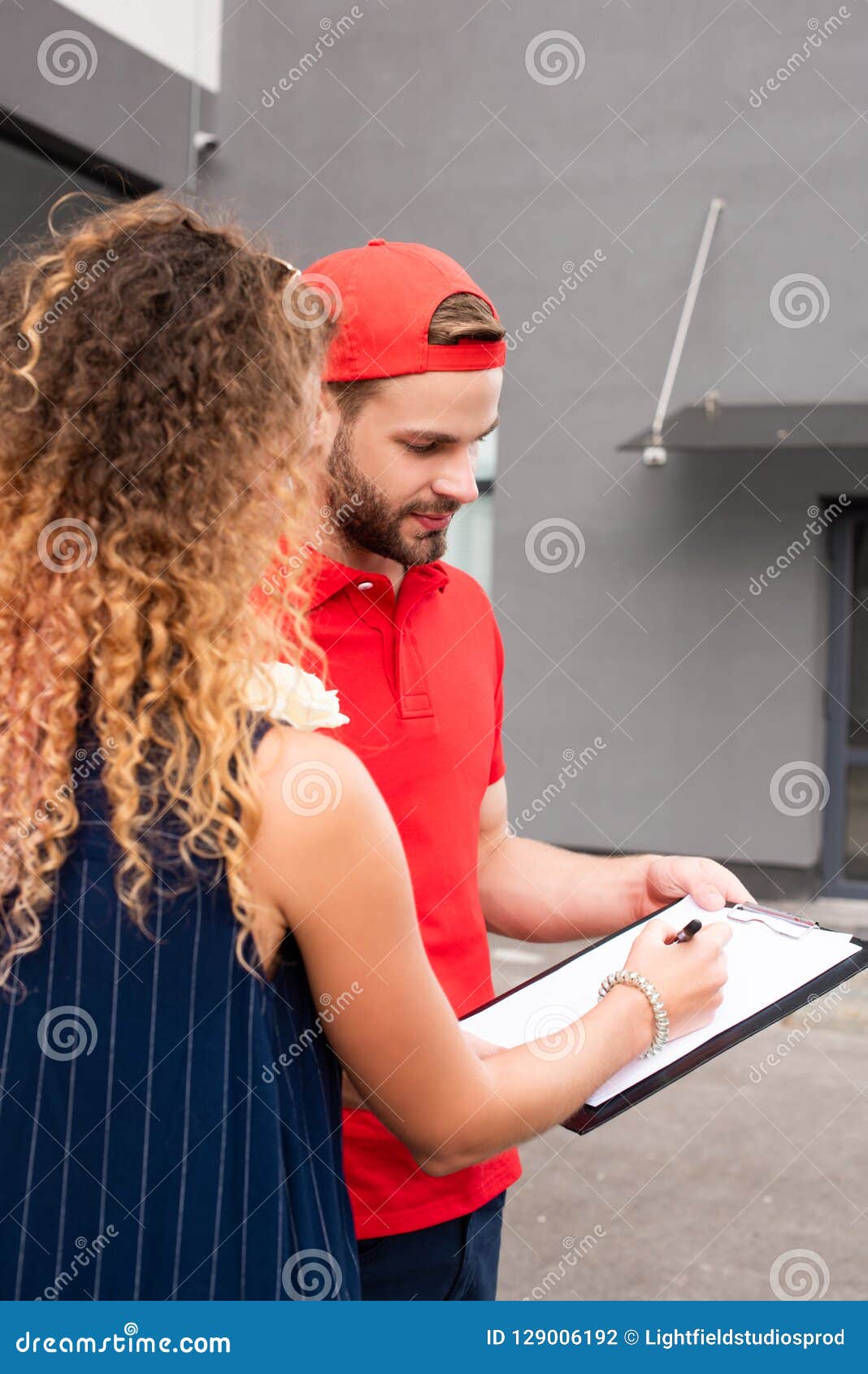 Partial View of Client Signing Document on Notepad in Delivery Stock ...