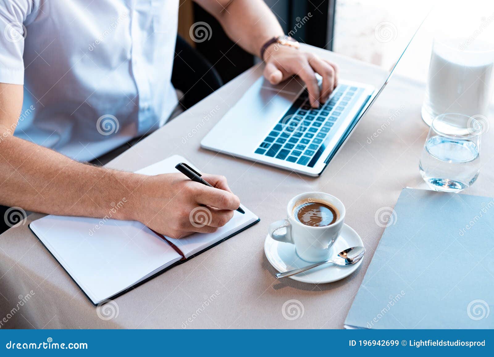 View of Freelancer Writing in Textbook and Typing on Laptop Keyboard in ...