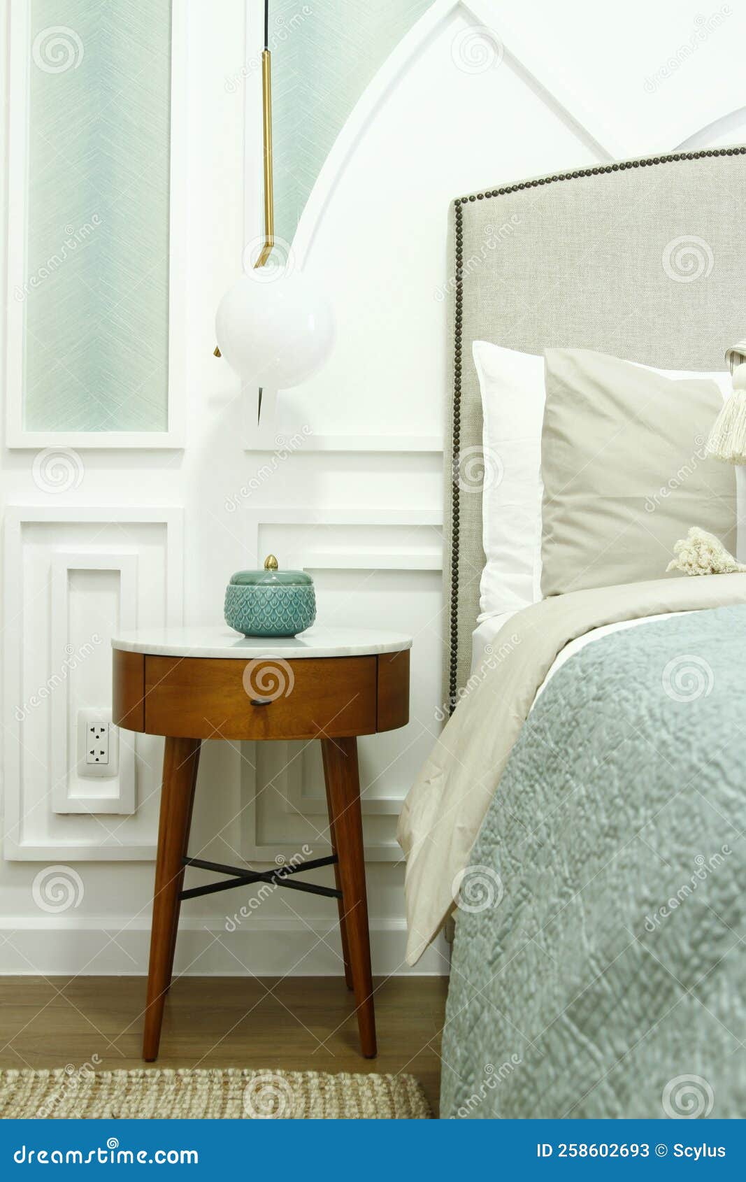 Partial View of a Large Bed with Circular White Headboard, with Side ...