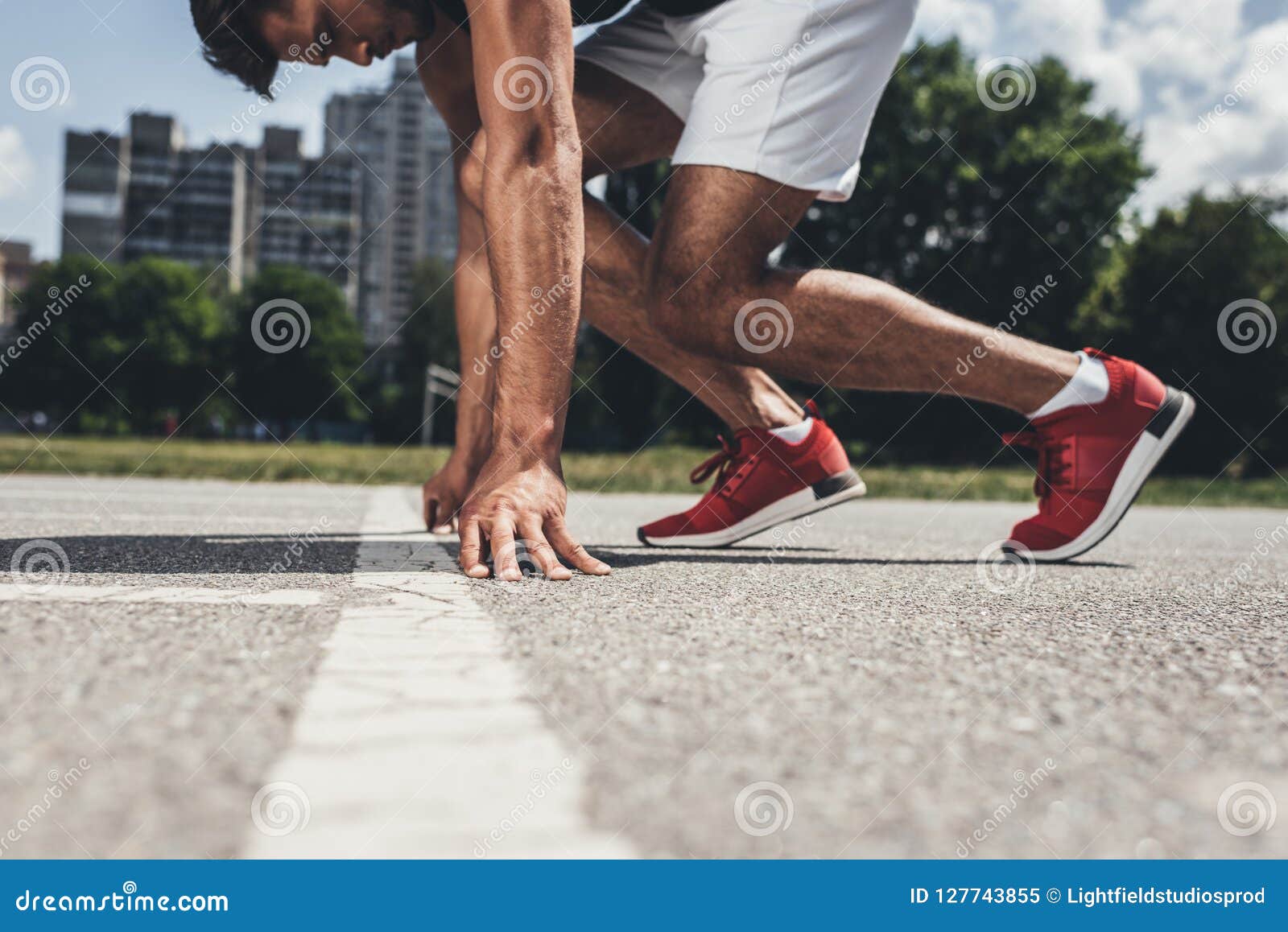 Partial View of Male Sprinter in Starting Position on Running Stock ...