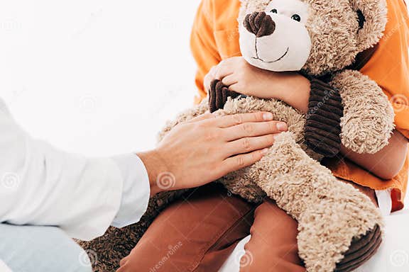 View of Pediatrist in White Coat and Kid with Teddy Bear Isolated on ... View of Pediatrist in White Coat and Kid with Teddy Bear Isolated on ...