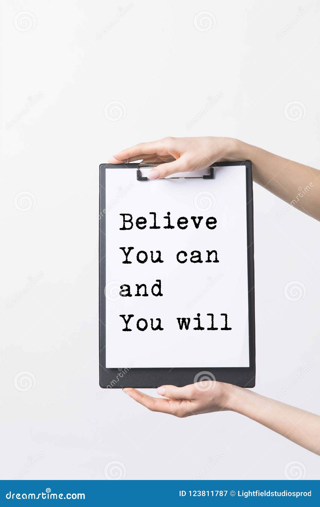 Partial View of Woman Holding Clipboard with Believe You Can and You ... Partial View of Woman Holding Clipboard with Believe You Can and You ...