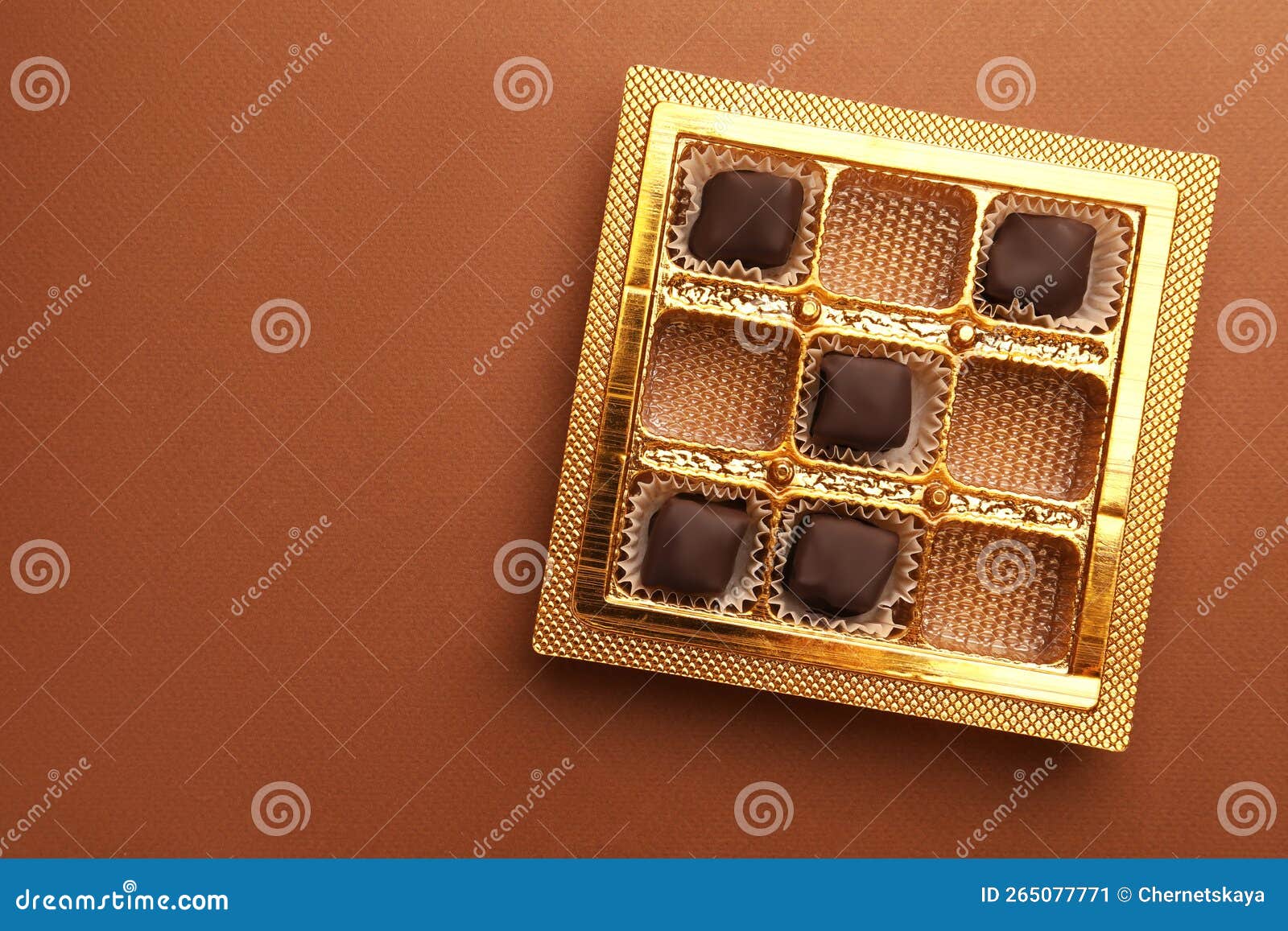 Partially Empty Box of Chocolate Candies on Brown Background, Top View ...