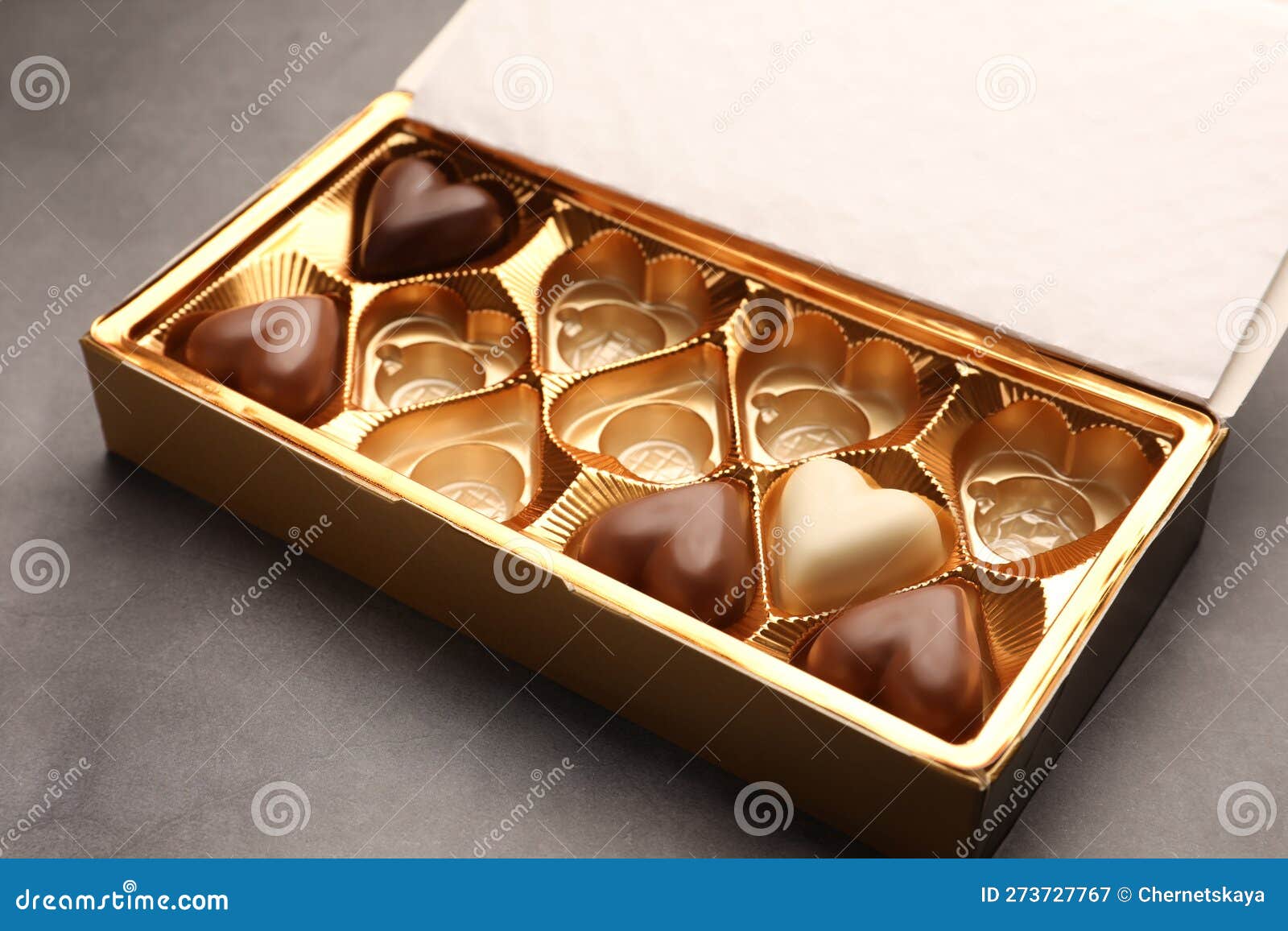 Partially Empty Box of Chocolate Candies on Grey Table, Closeup Stock ...