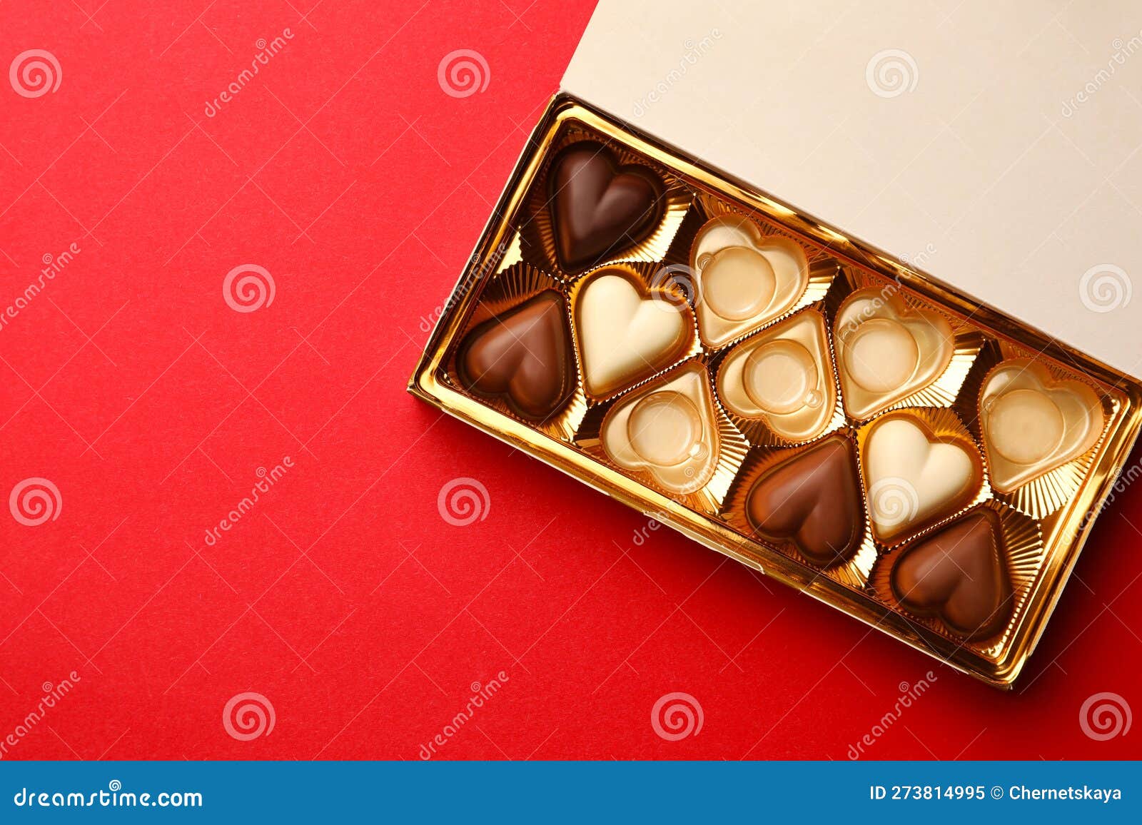 Partially Empty Box of Chocolate Candies on Red Background, Top View ...