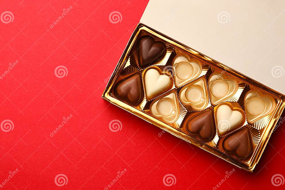 Partially Empty Box of Chocolate Candies on Red Background, Top View ...