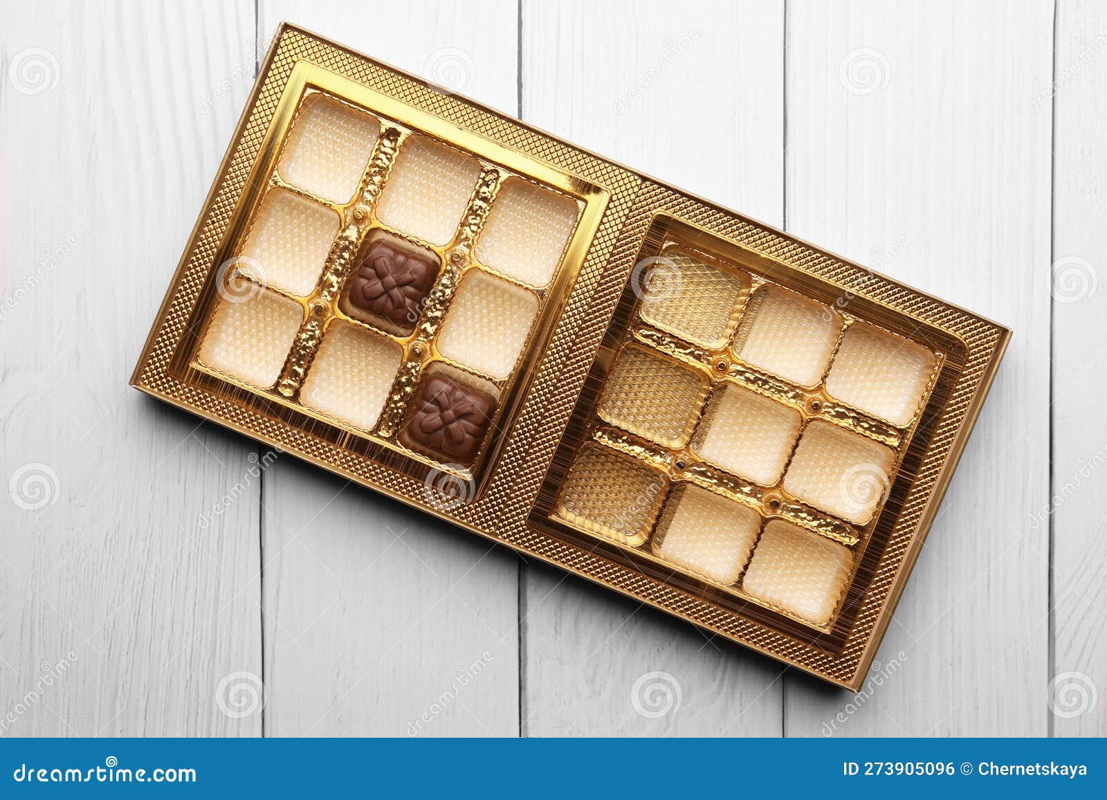 Partially Empty Box of Chocolate Candies on White Wooden Table, Top ...