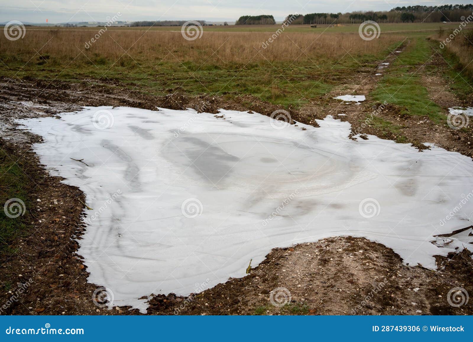 Partially Melted Ice Puddle in a Field Stock Photo - Image of ...
