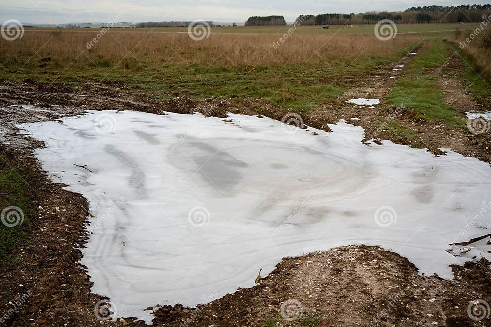 Partially Melted Ice Puddle in a Field Stock Photo - Image of ...