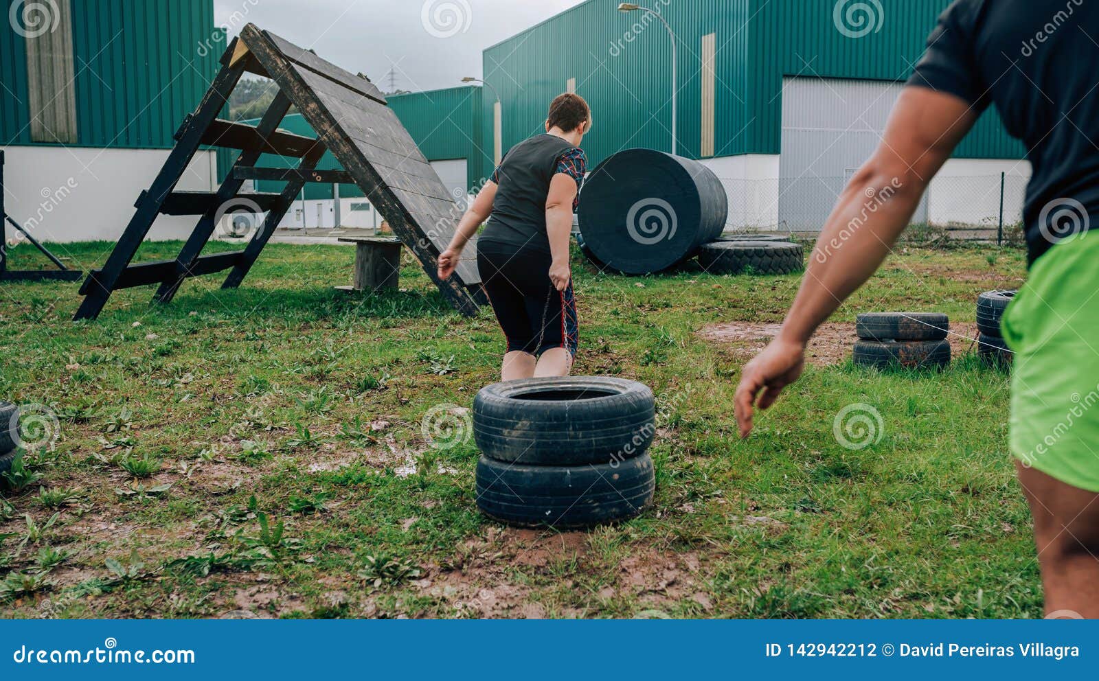 Participant in an Obstacle Course Dragging Wheels Stock Photo - Image ...