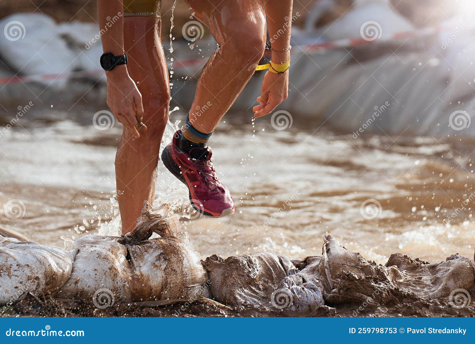 Participant in an Obstacle Course Race Runs Out of a Water Obstacle ...