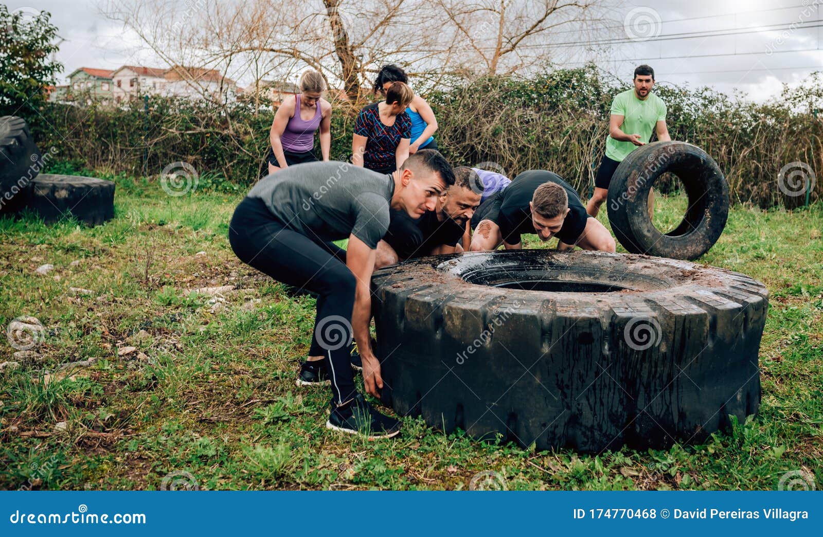 Participants in an Obstacle Course Turning a Wheel Stock Photo - Image ...