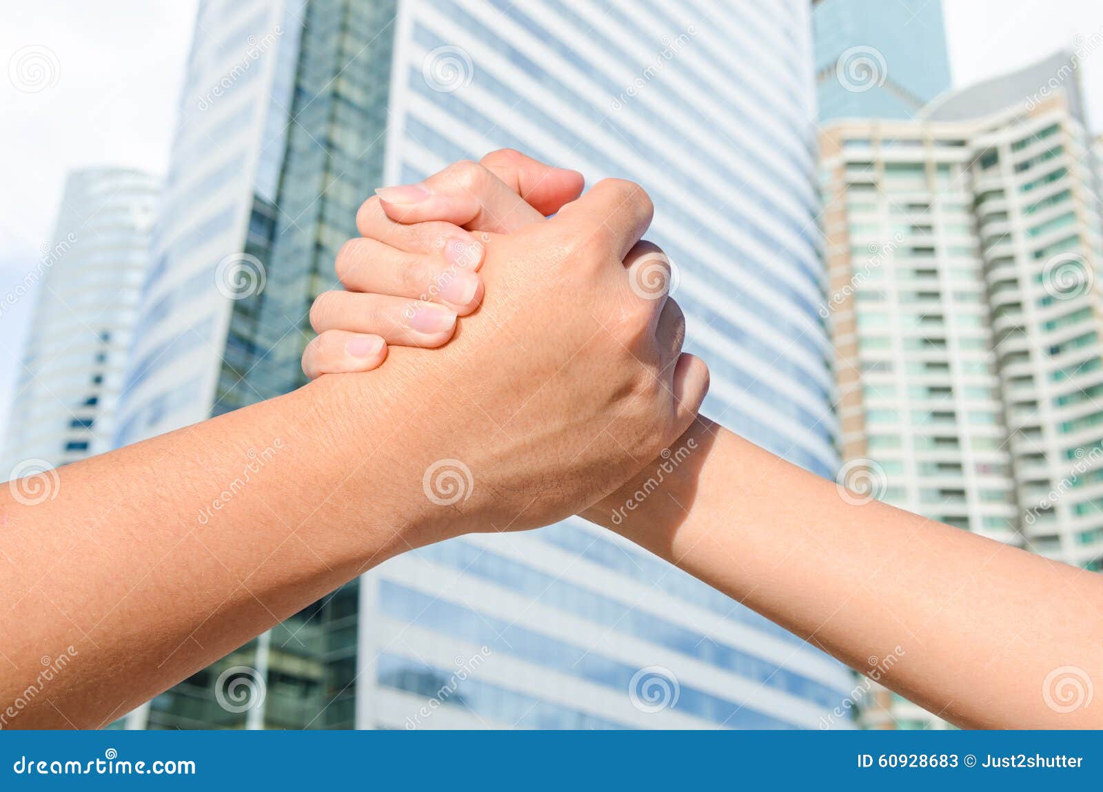 Partner Hand between a Man and a Woman on Building Background Stock ...