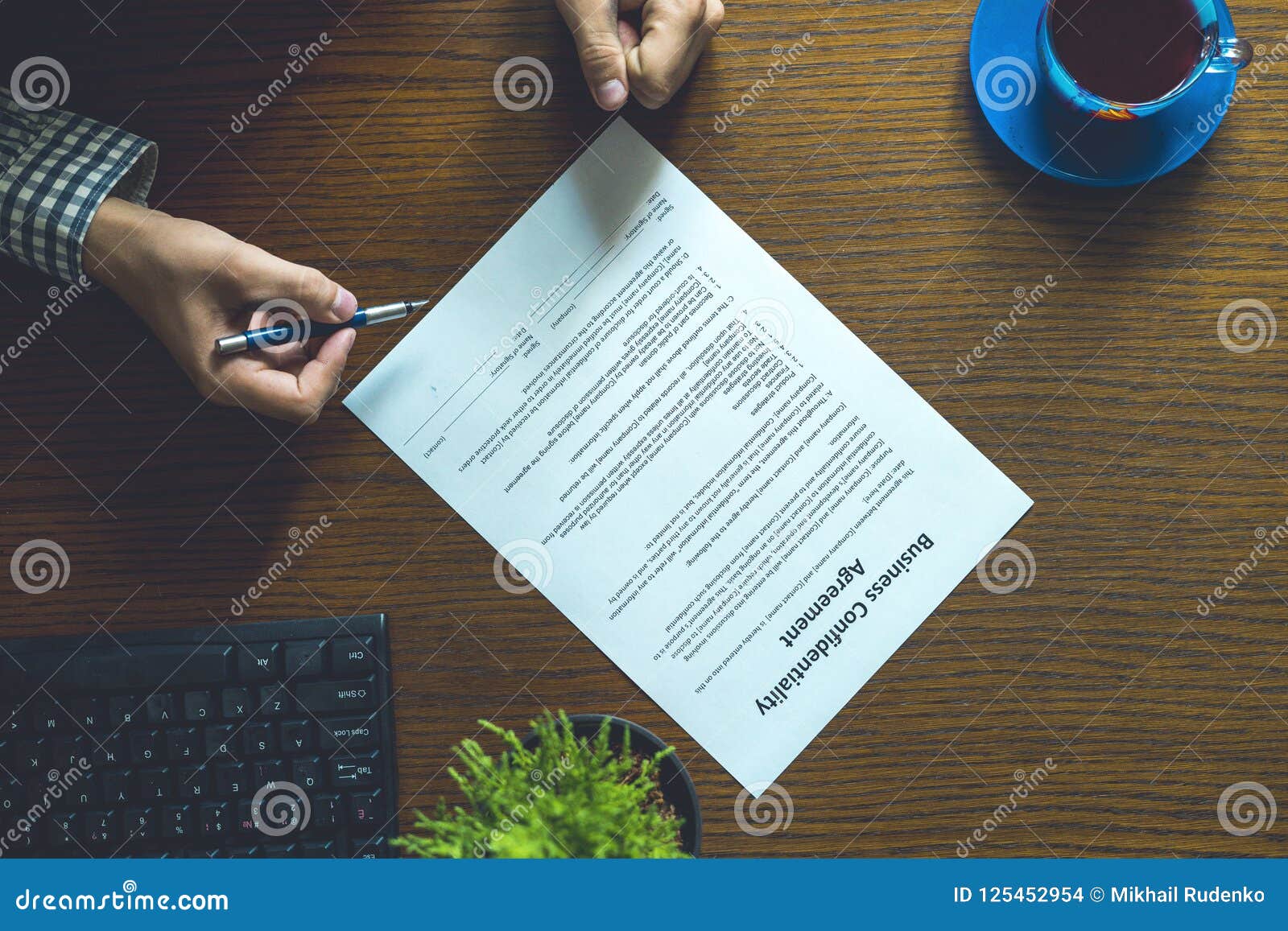 Partnership Agreement Business Document Signed by a Person on the Table ...
