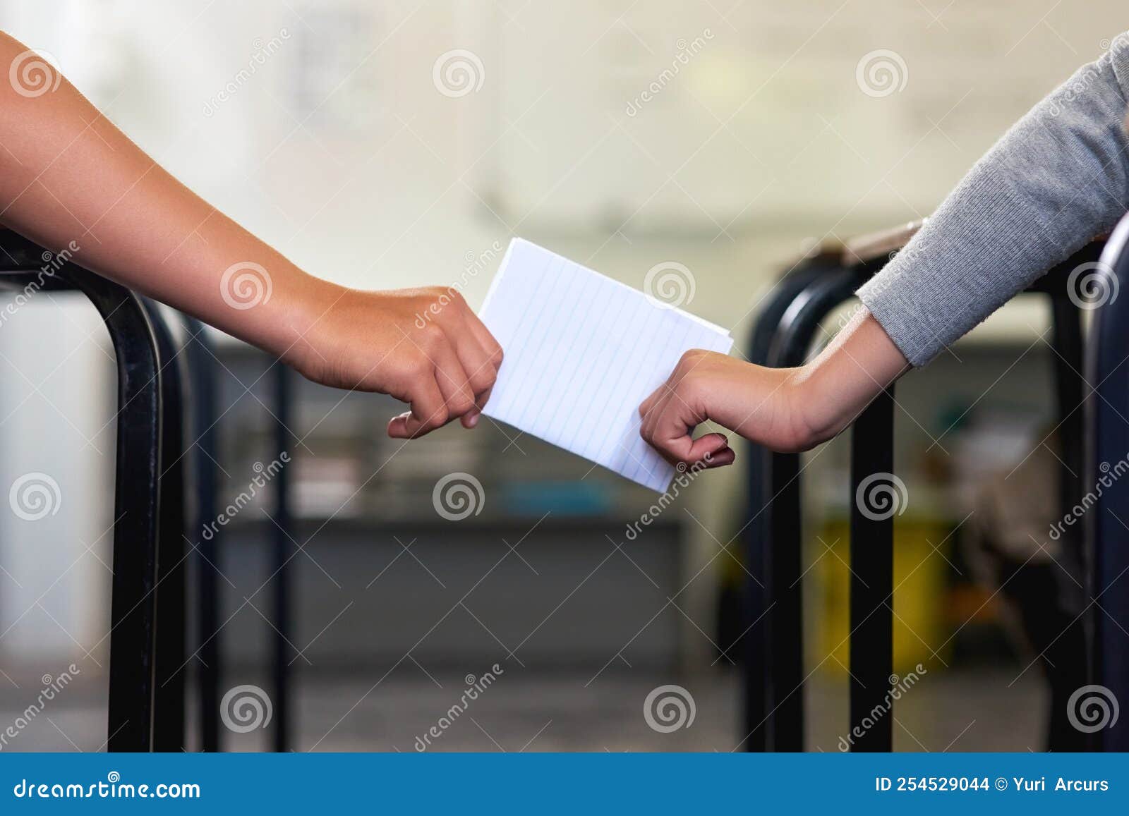 Pass it on. Two Unidentifiable Schoolchildren Passing a Note in Class ...