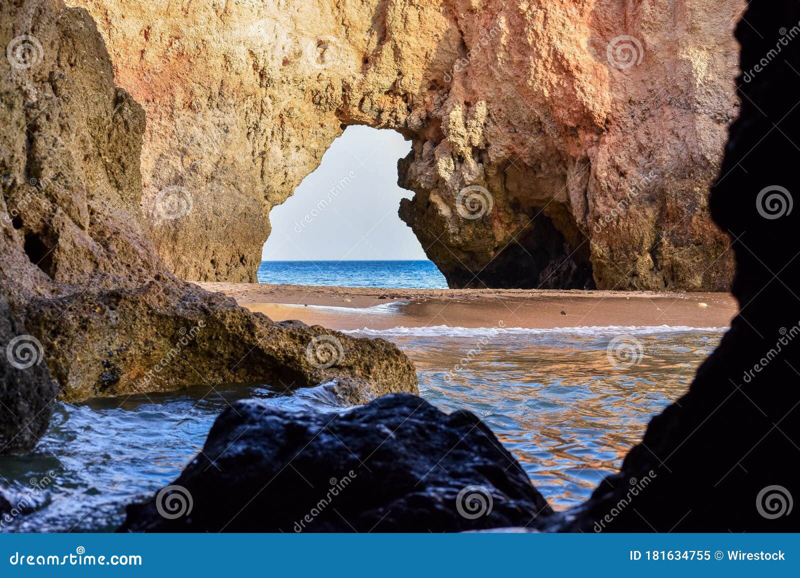 Passageway Created through the Cliff Over the Water Stock Image - Image ...