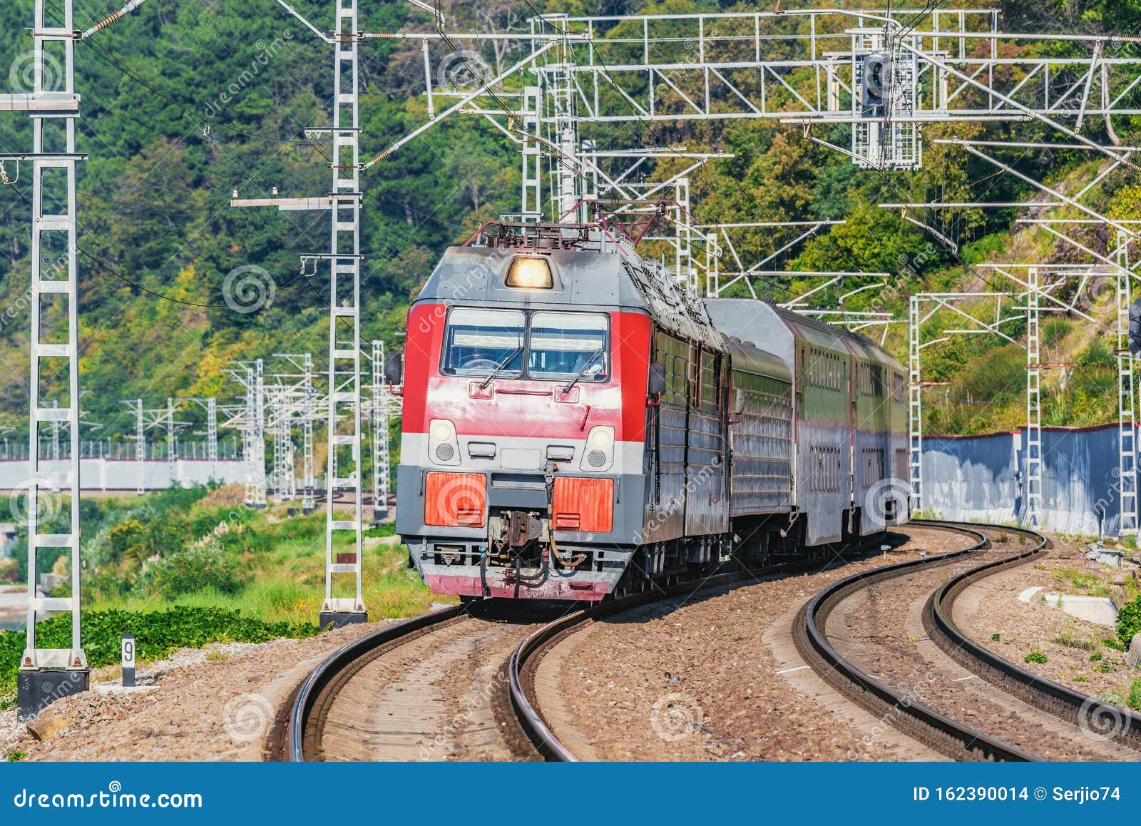 Passenger Double Deck Train Moves Along the Mountains Stock Photo ...