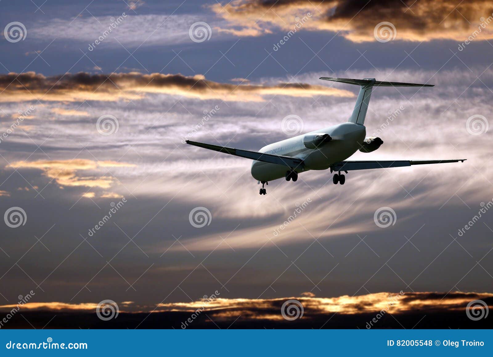 Passenger Jet Plane Flying in the Evening Sky at Sunset Stock Photo ...