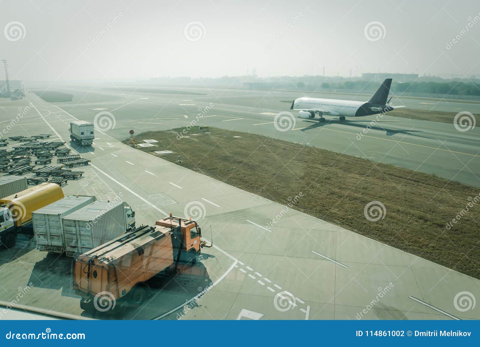 A Passenger Plane Being Serviced by Ground Services before Next Takeoff ...