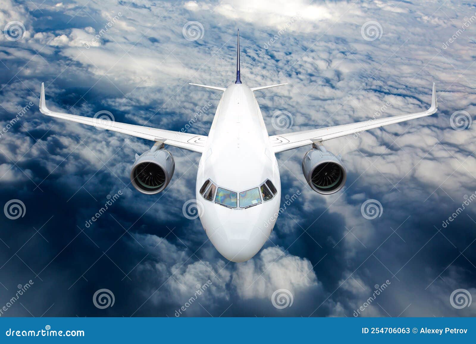 Passenger Plane Fly High in the Sky Above the Clouds. Front View Stock ...