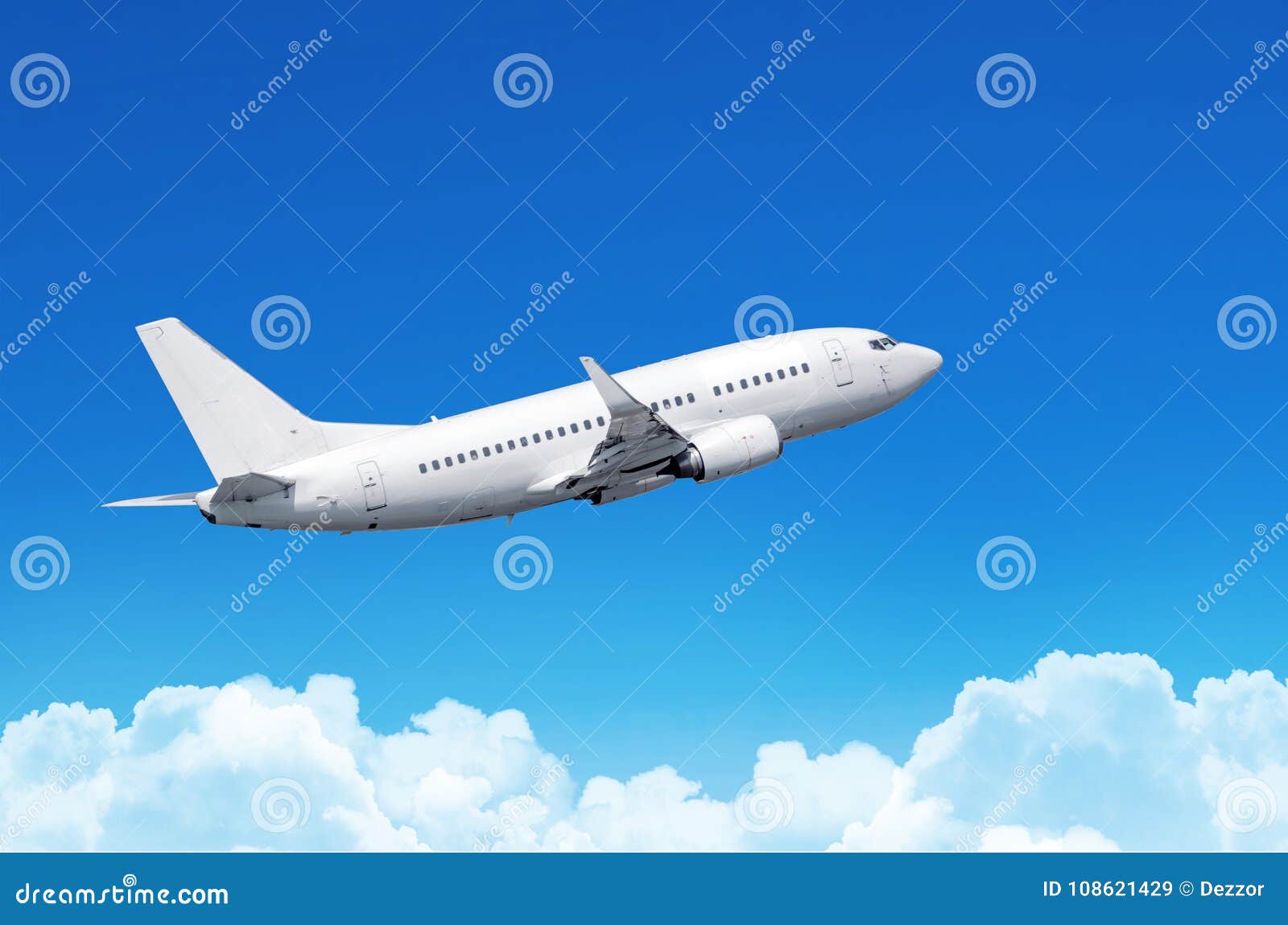 Passenger Plane Fly on a Train Above Clouds and Blue Sky. Stock Image ...